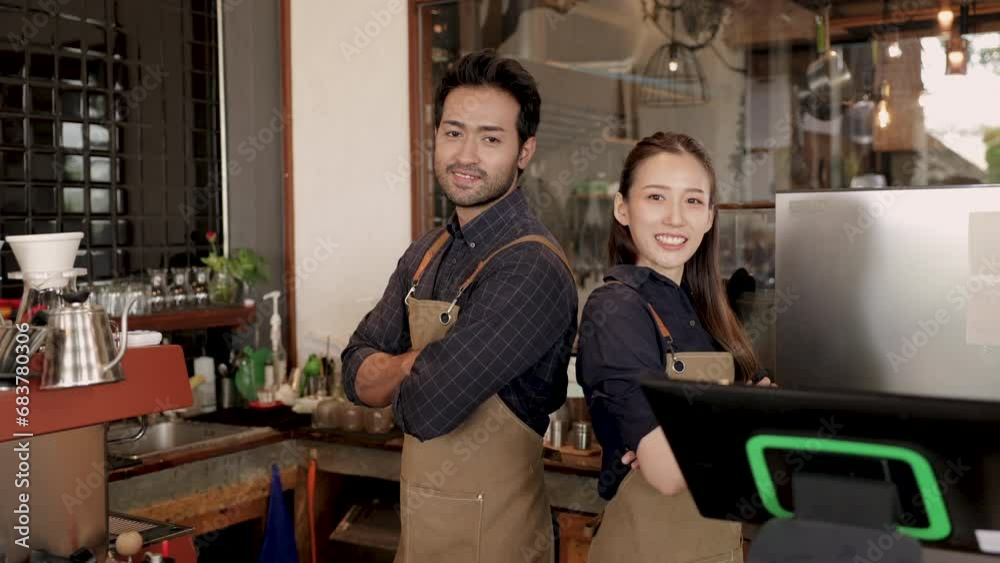 Two young barista running coffee shop standing behind bar counter and ...