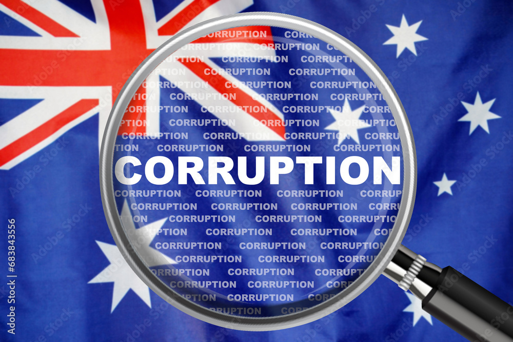 Loupe focused on the word corruption on Australia flag background ...