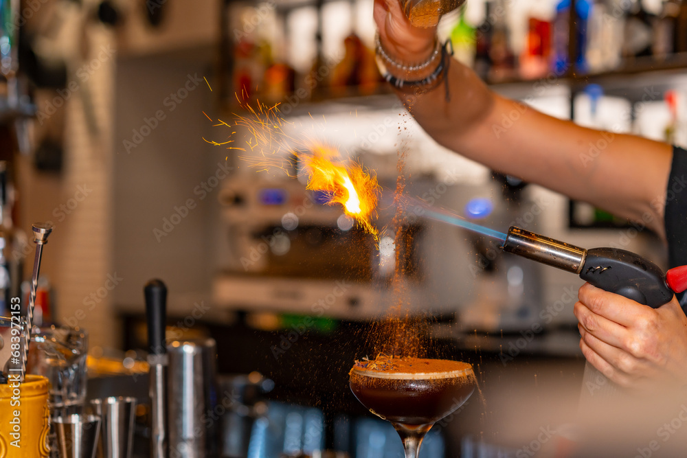 Bartender burning the topping of a cocktail using torch Stock Photo ...