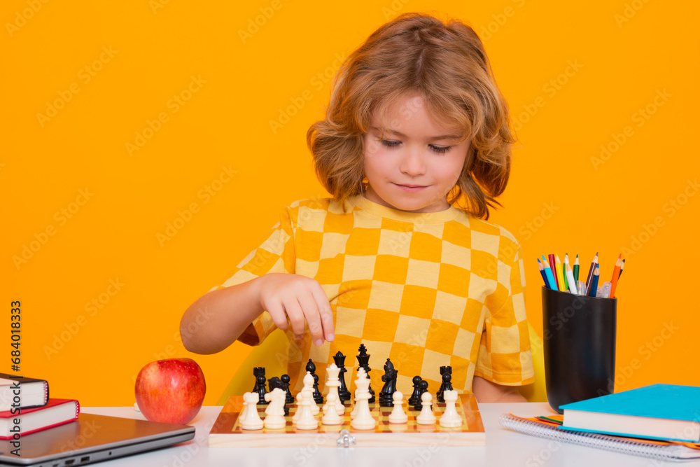 Child play chess on studio background. Little kid play chess. Thinking ...