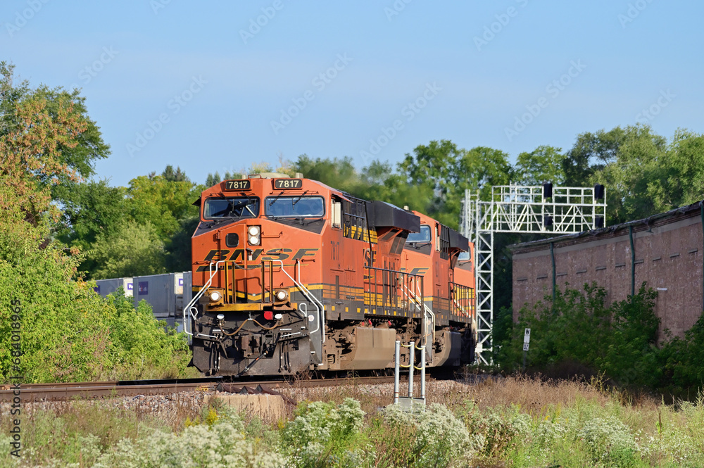 Burlington Northern Santa Fe Railway locomotives lead an intermodal freight train westbound ...