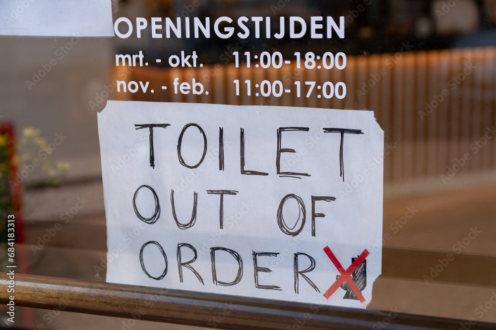 Toilet out of order sign on the front window of a cafe Stock Photo ...