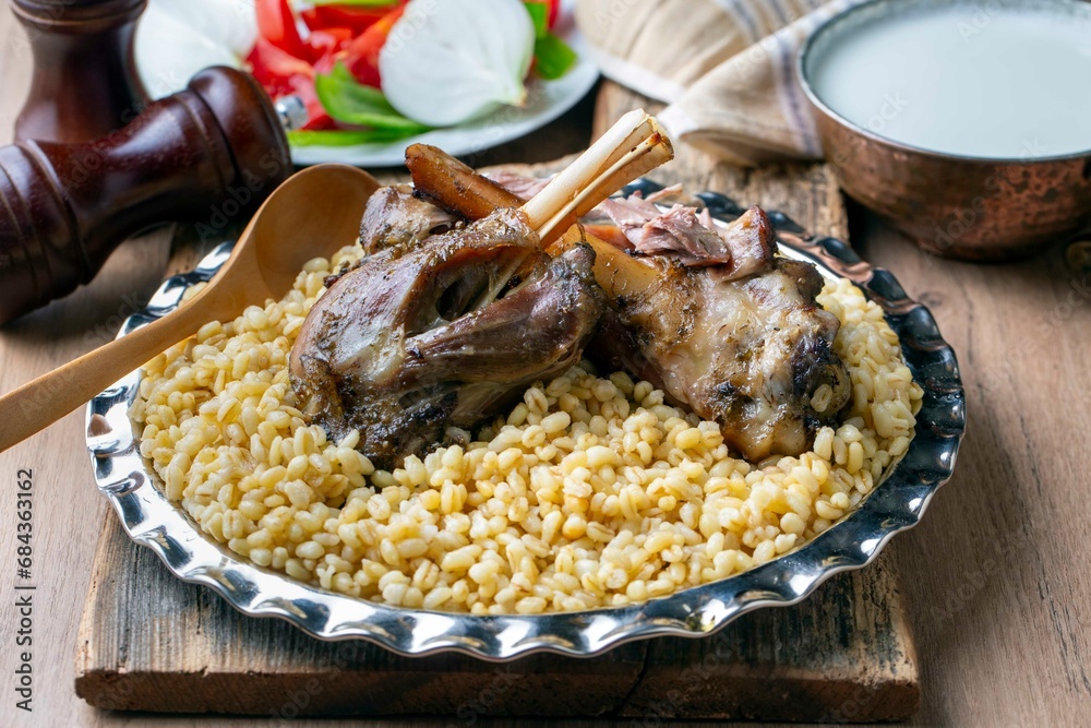 Turkish foods; lamb shank tandoori on bulgur wheat rice (Turkish name ...