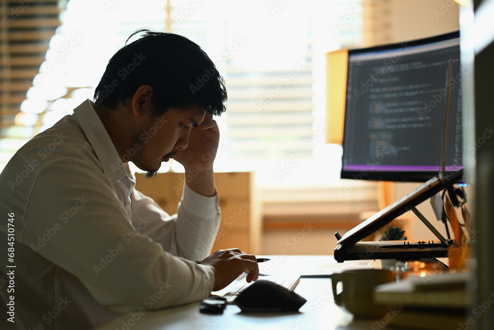 Shot stressed male software developer programming code on computer ...