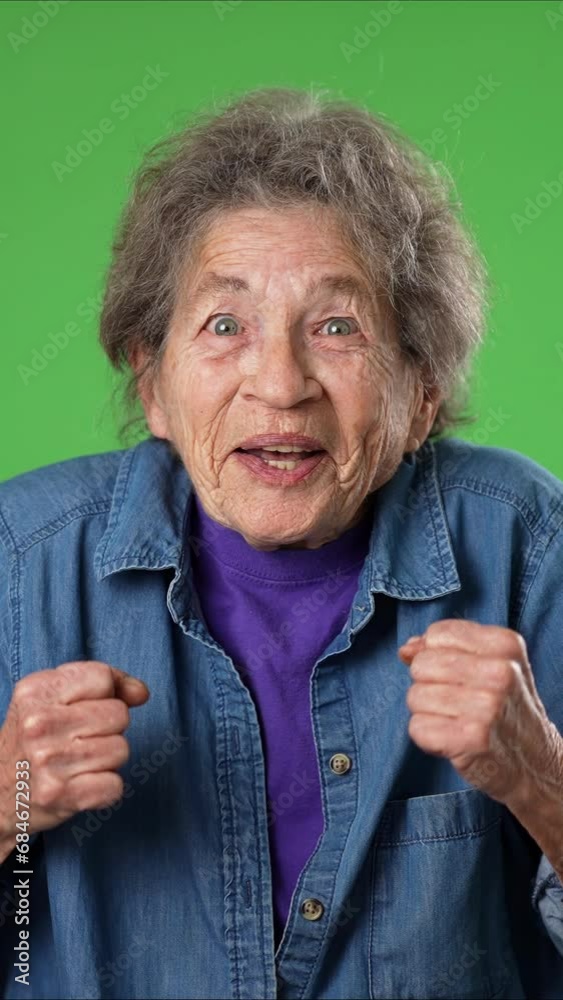 Vertical video slow motion portrait of excited surprised elderly senior ...