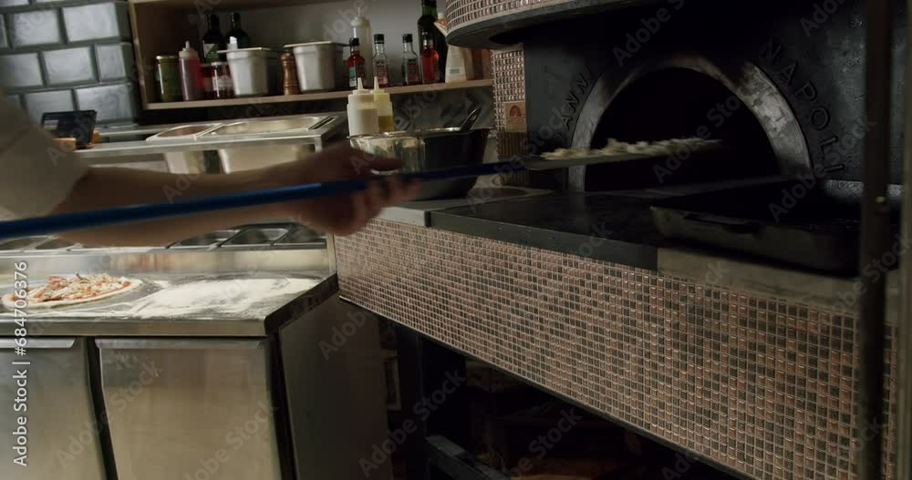 The chef prepares pizza in the restaurant kitchen. Italian Neapolitan ...
