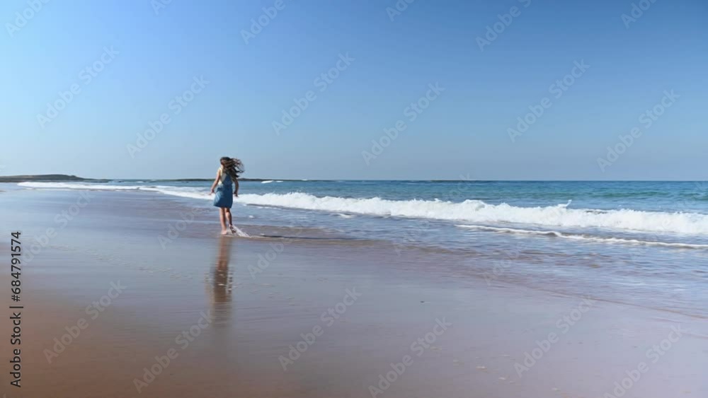 Full length portrait of a happy little child girl playing barefoot on ...