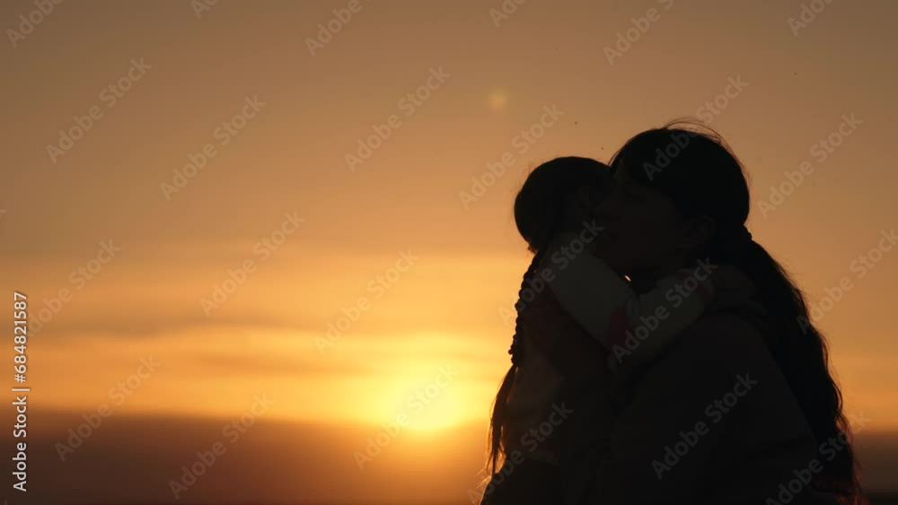 Happy family hugging in front of sun. Child playing with mom happy hugs ...