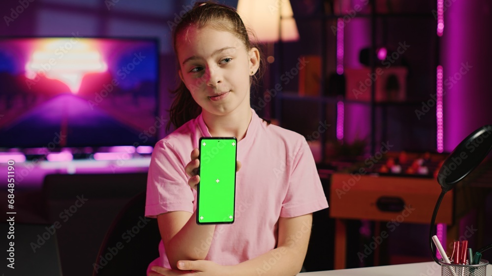 Kid content creator filming technology review of newly released green ...
