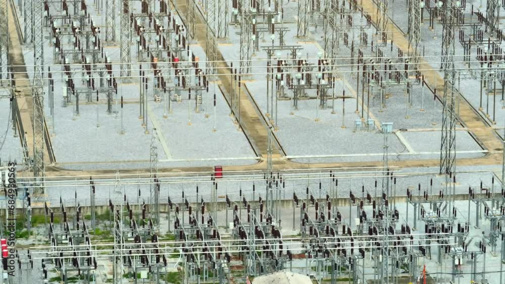 A high voltage power station, a silent sentinel of energy, stands tall ...