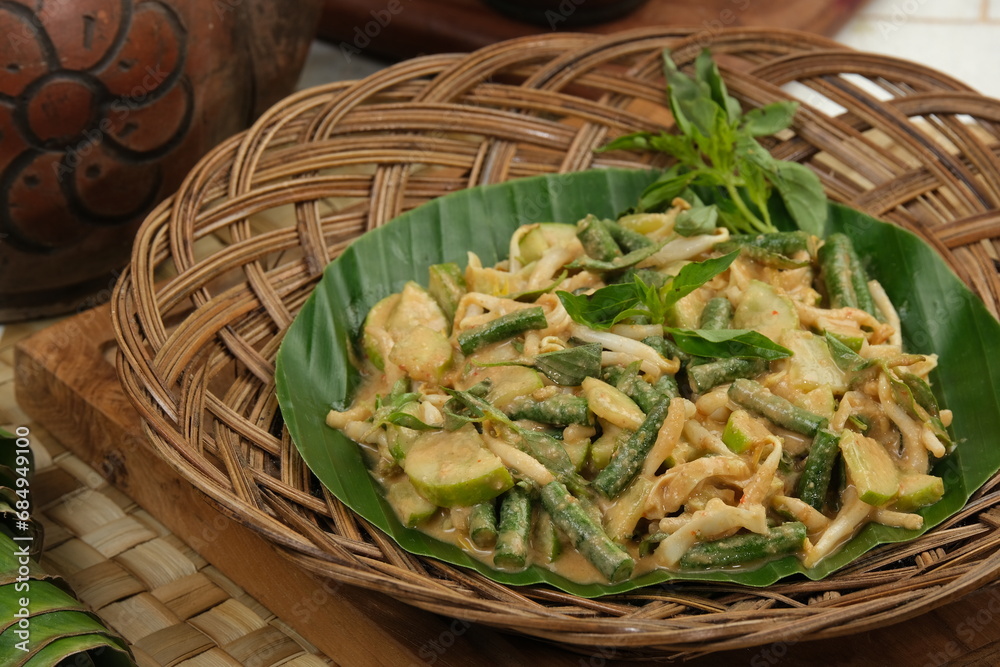 Karedok or keredok is raw vegetables salad covered in spicy peanut ...