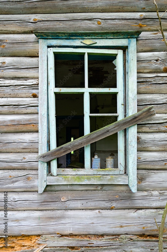 Boarded up window with broken glass in abandoned elementary school in ...