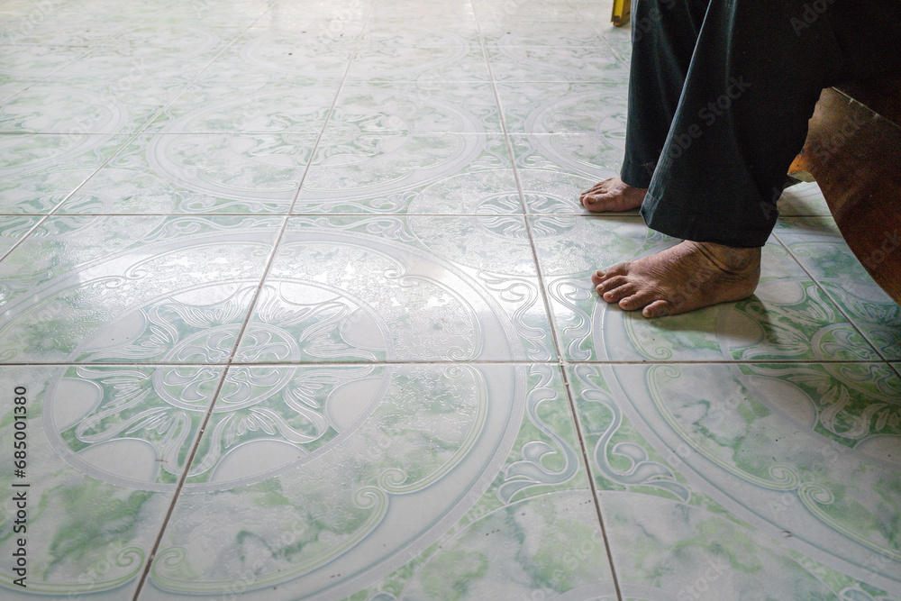 Legs of the old man on the tiles in the Buddhist temple Stock Photo ...