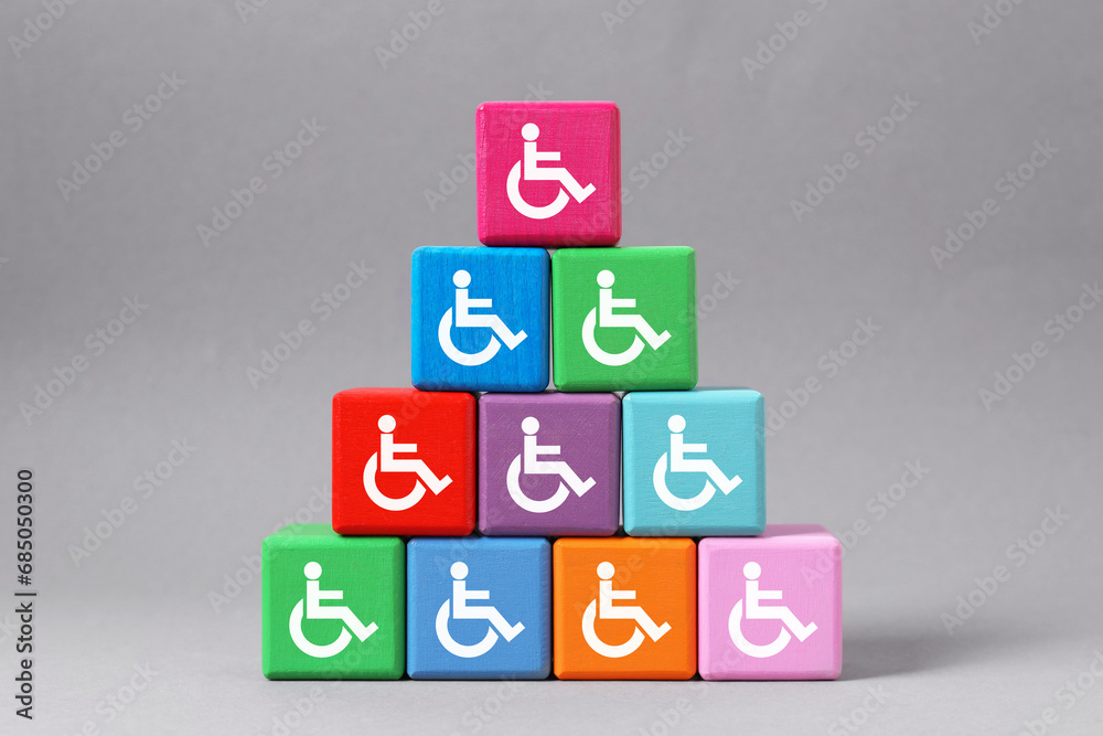 Inclusion concept. Pyramid of colorful cubes with international symbols ...