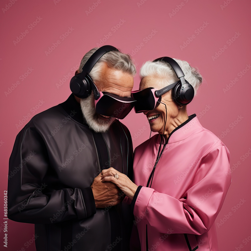 Senior couple laughing, wearing extended reality headsets in a studio ...