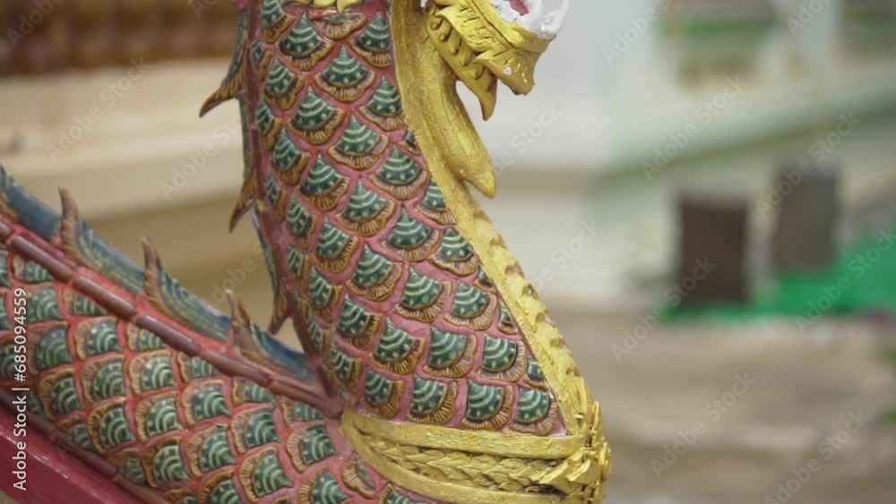 The Naga statue on the steps of the temple is decorated with stucco ...