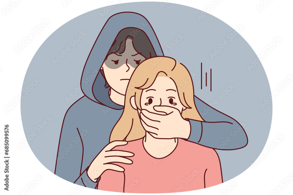 Man in hood close scared woman mouth with hand. Male criminal or ...