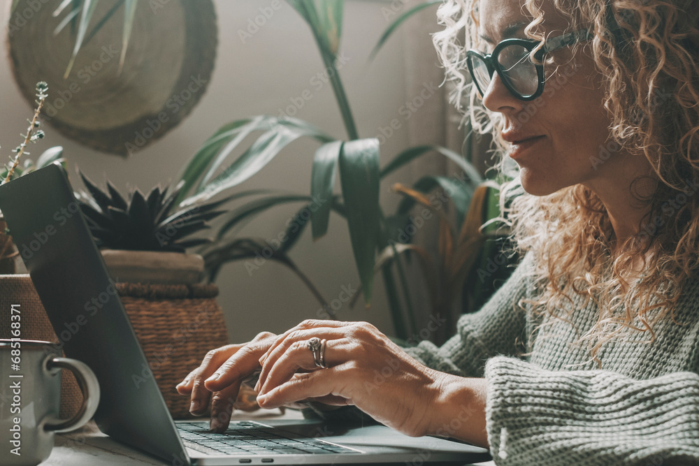 One woman at home using laptop in green mood color background and ...
