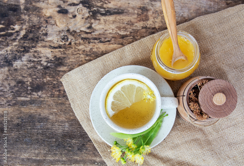cup of herbal linden tea with lemon slice and honey. Flu treatment and ...