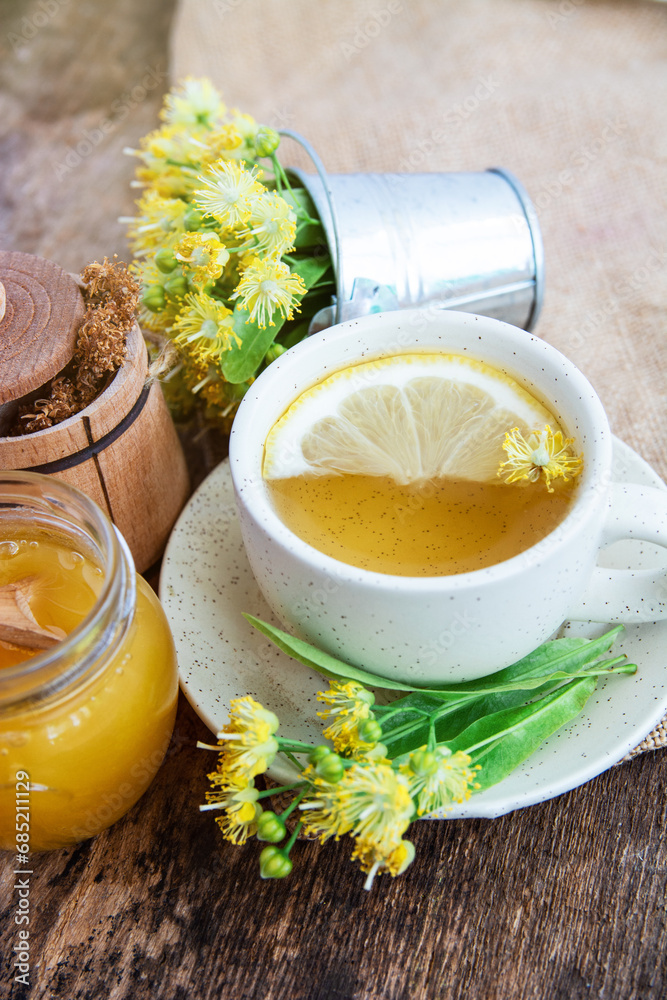 cup of herbal linden tea with lemon slice and honey. Flu treatment and ...