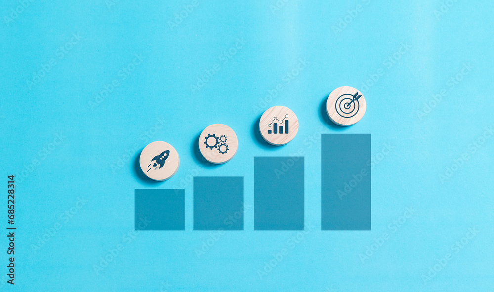 Wooden block with operations management icons for business process and ...