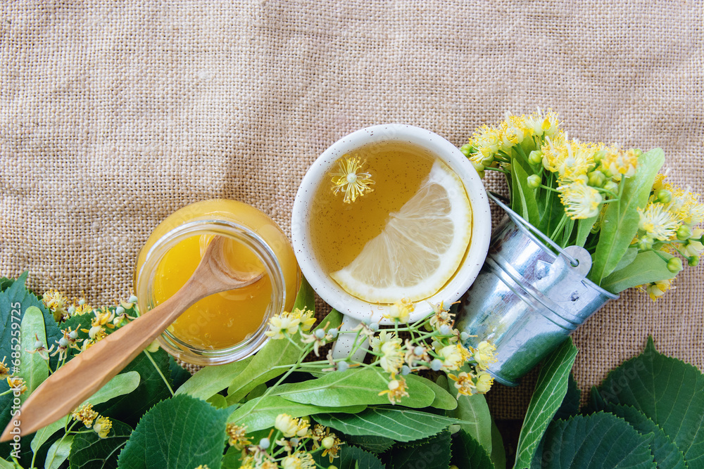 linden tree branch and inflorescence of linden flowers, cup of herbal ...