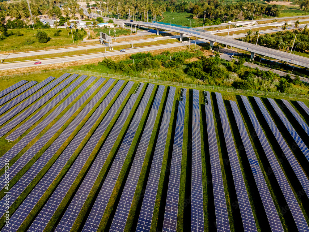 Sun power solar panel field near a highway road with traffic, Solar ...