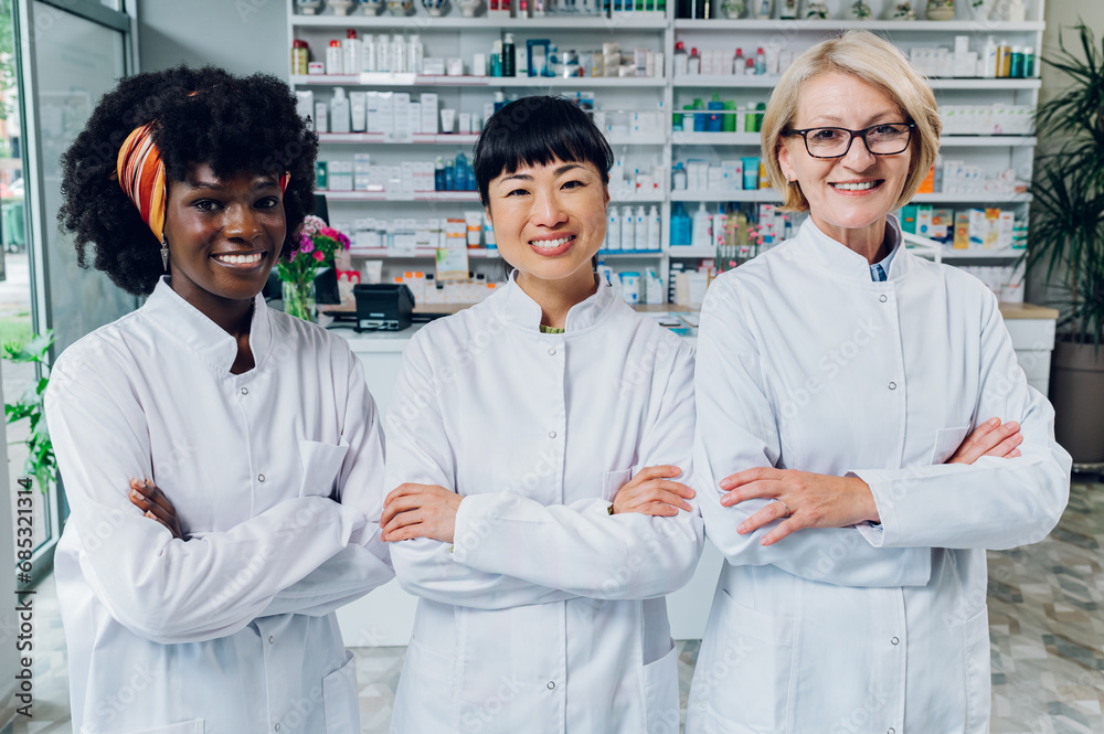 Three multiracial female pharmacists are posing in a pharmacy. Stock ...