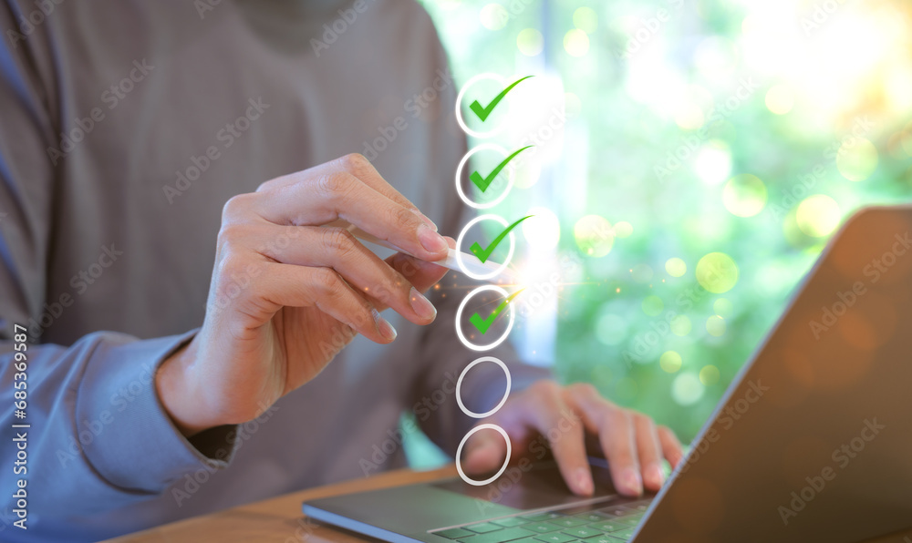 Man using pen to tick correct sign mark in checkbox for quality ...