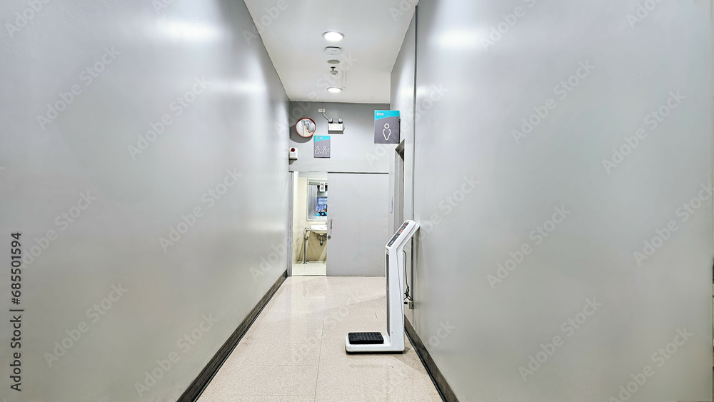 Long corridor with toilet sign. Empty public toilet corridor. Walkway ...