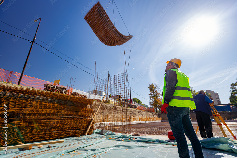 Construction worker with safety helmet at construction site as crane ...