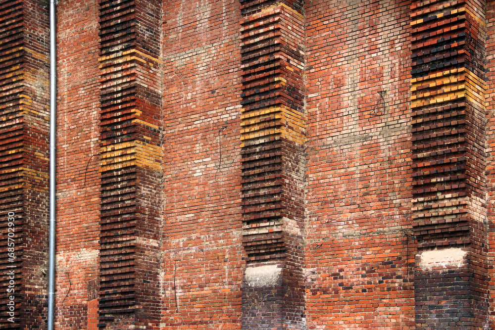 Old red brick wall with protruding blocks as background Stock Photo ...