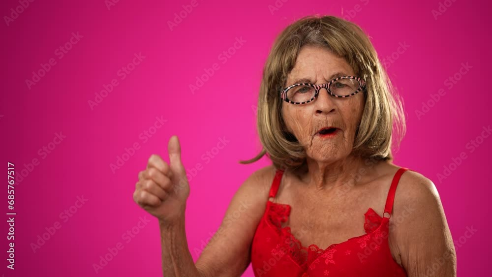 Funny elderly mature woman, 80s, wearing negligee and glasses giving ...