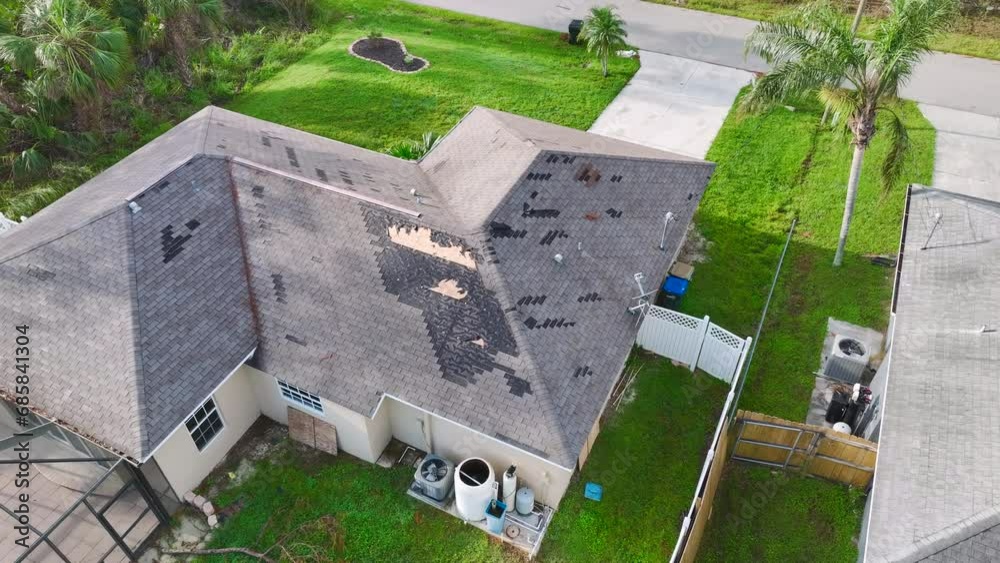 Top view of leaking house roof covered with protective tarp sheets ...