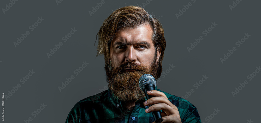 Bearded man singing with microphone. Male singing with a microphones ...