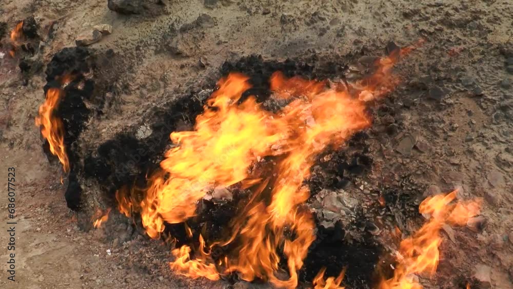 Ecology, global warming. Fire. Flames of burning gas from the surface ...