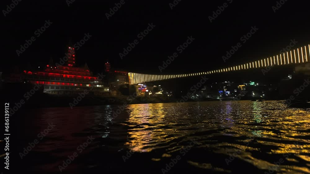 Rishikesh City at night, Ram Jhula bridge situated on Holy River Ganga ...