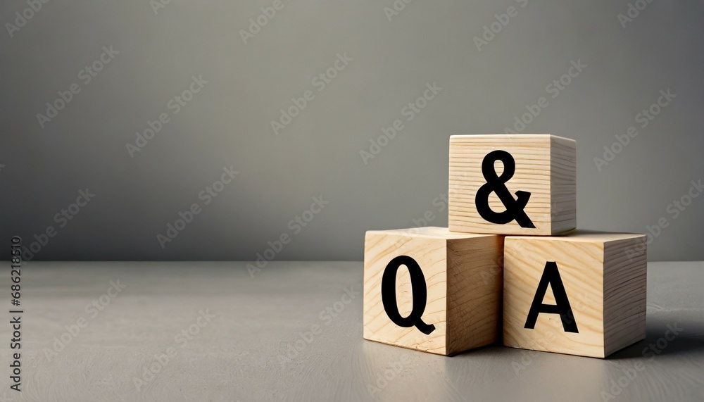 q and a concept q and a symbols on wooden cube block on a grey ...