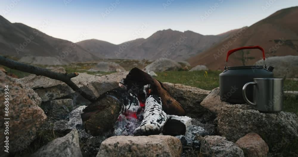 Burning campfire in morning. Camper extinguishes fire that has served ...