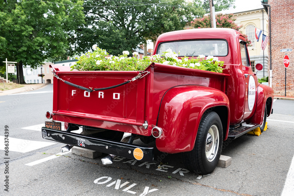 Restored red pickup truck from the 50s, Ford F100 in the parking lot ...
