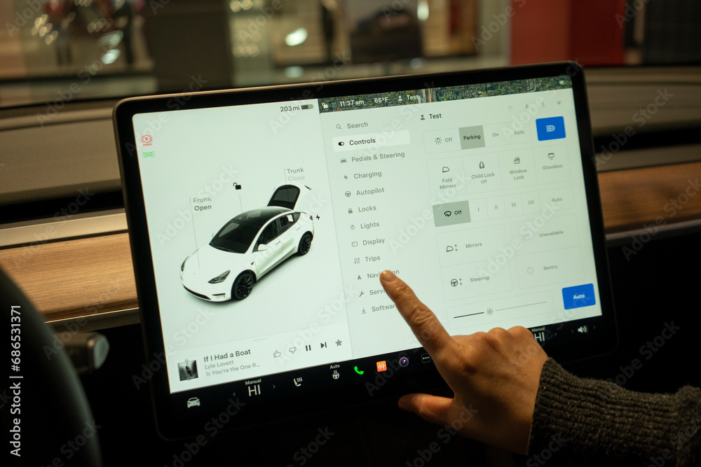 Tigard, OR, USA - Nov 30, 2023: A woman tries out the functions on the ...