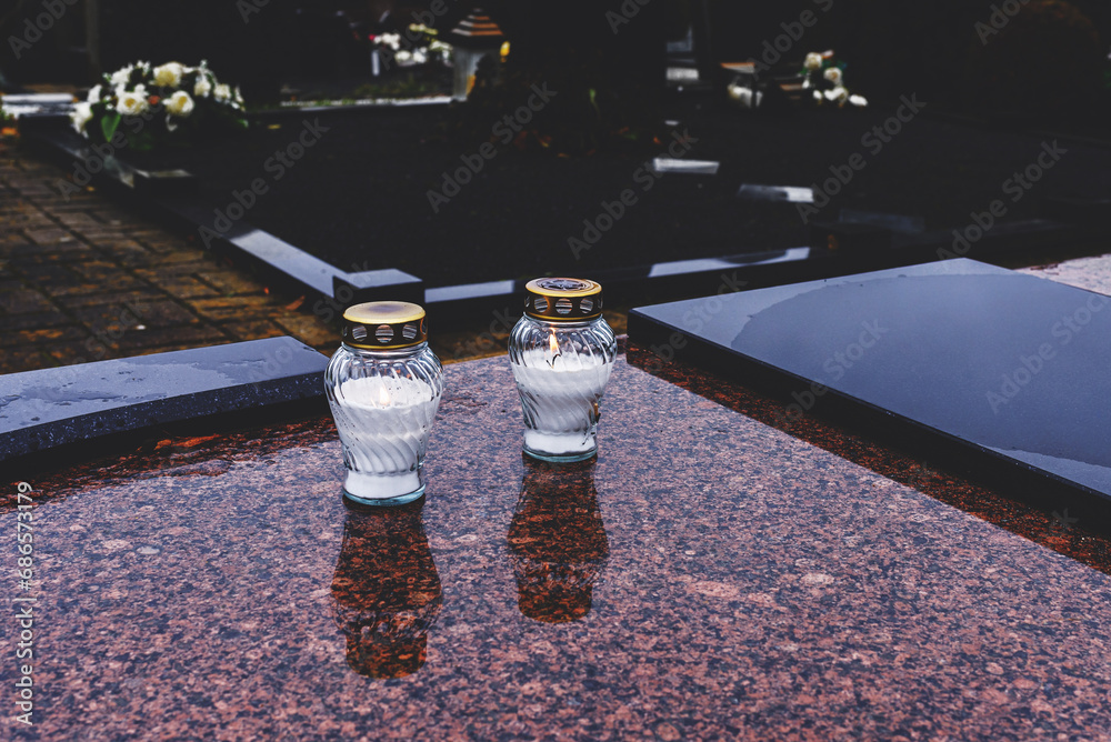 Grave candle light.Graves in a cemetery.Catholic cemetery background. All saints holiday.Grave ...