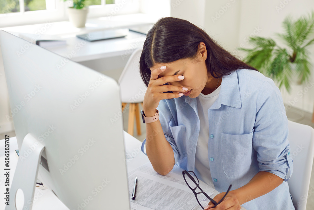 Stressed, tired, sad, depressed, overworked woman sitting at her office ...