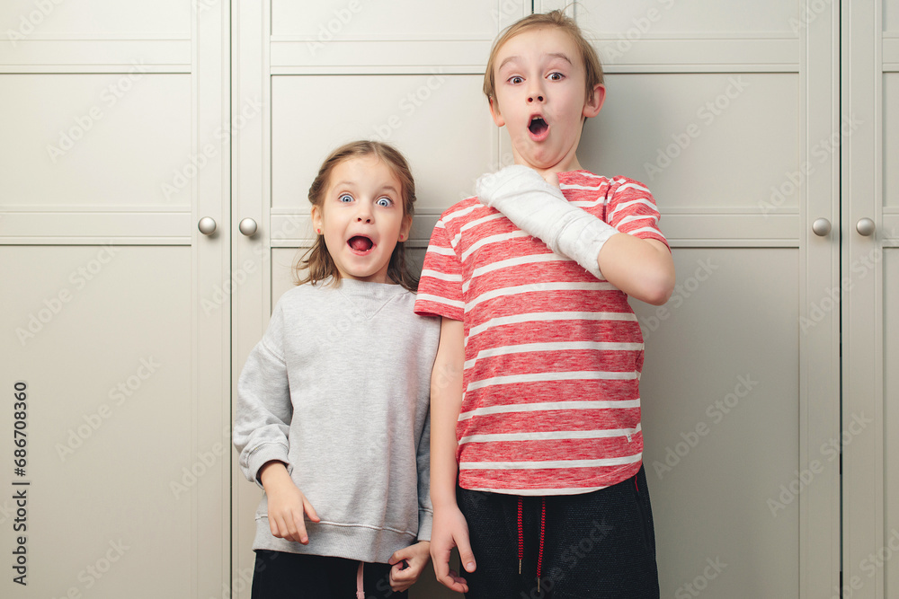 Boy broken arm, girl and boy is in shock. Shocked surprised boy with ...