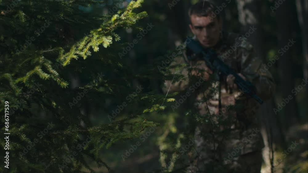 Young Soldier Comes to a Pine Tree and Observes the Forest With a Rifle ...