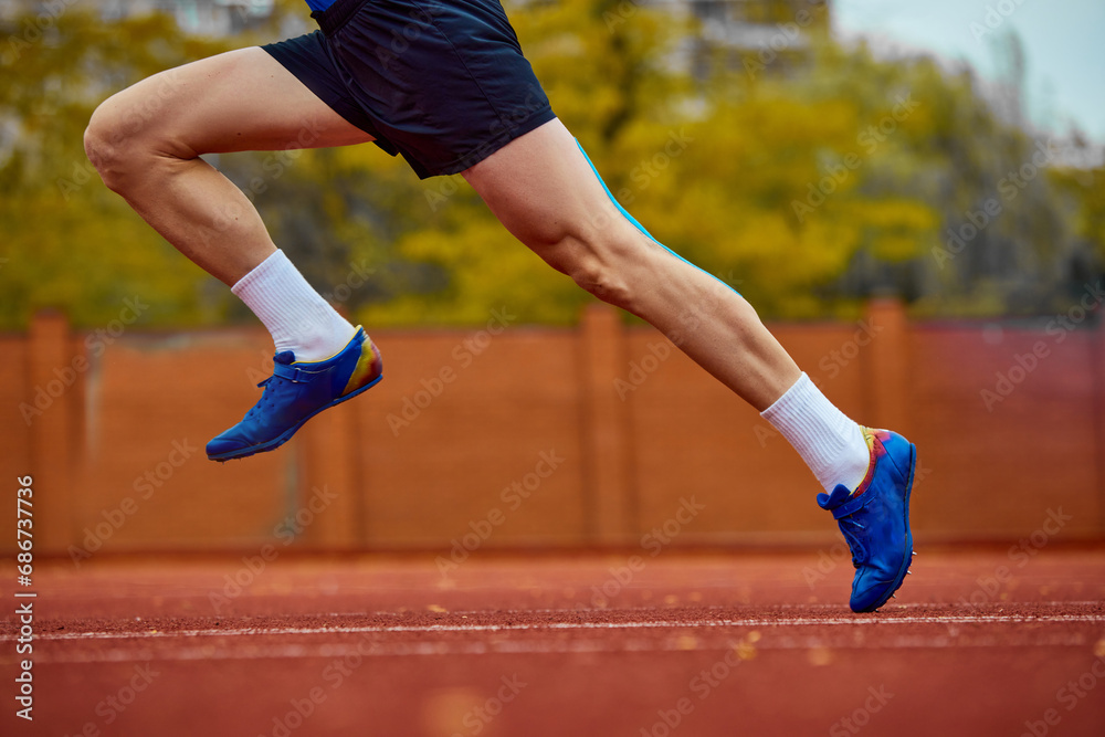 Focused sprinter on the verge of takeoff. Side view cropped photo of ...