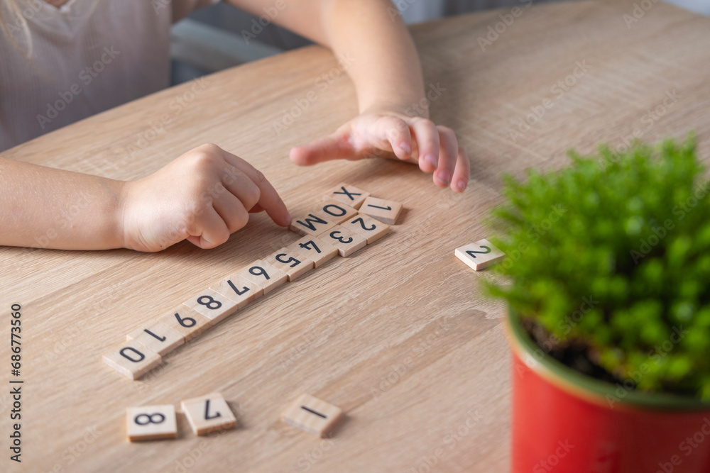 preschooler learning to count, Child studying numbers on wooden squares ...