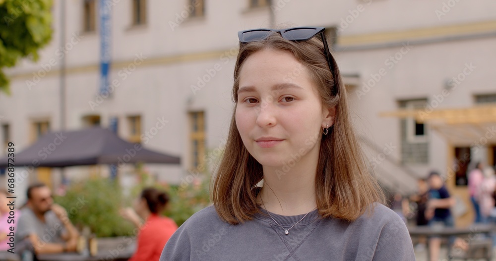 Youth portrait of teenage girl student in urban surroundings gazing ...