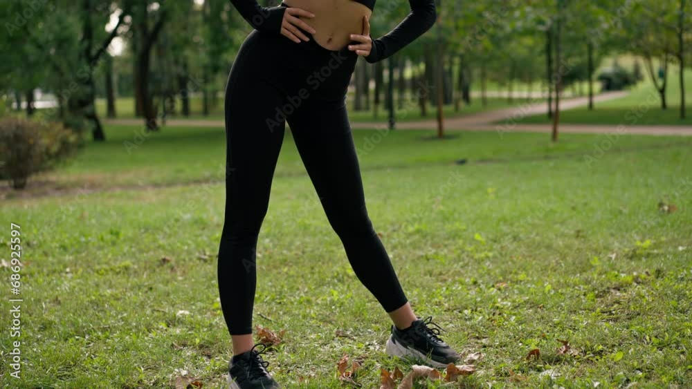 close-up A sports girl during a morning workout in fresh air makes ...