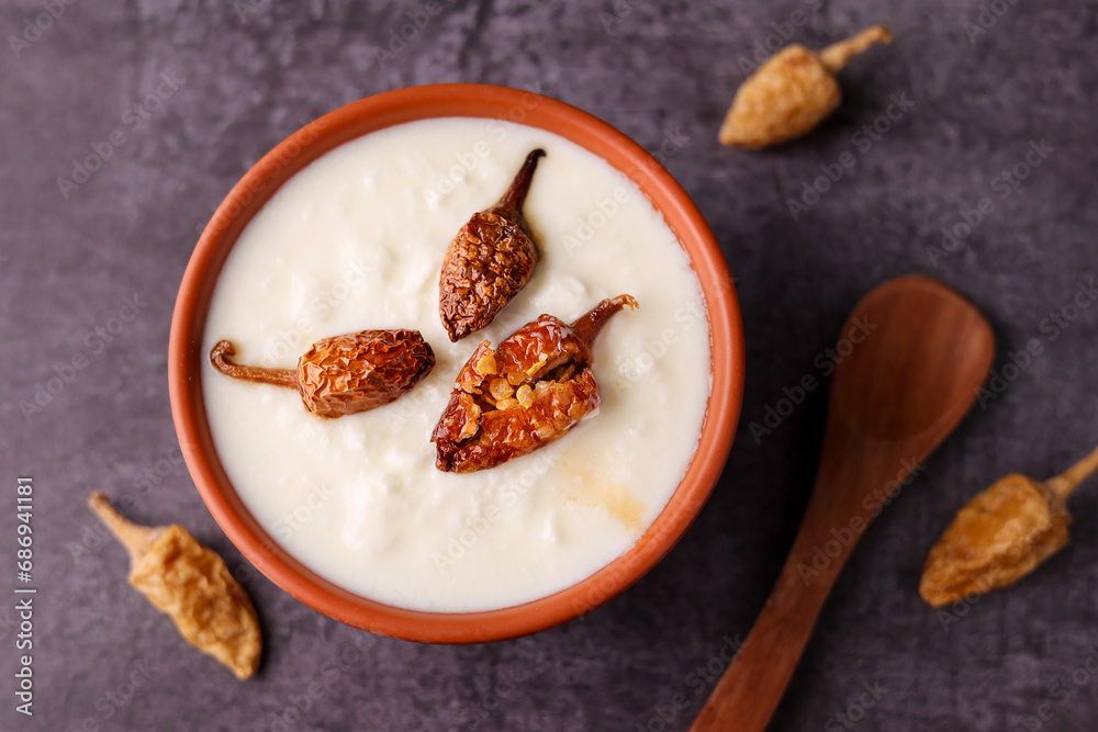 Bowl of homemade sour cream curd yogurt Dahi fresh herbs curry leaf ...